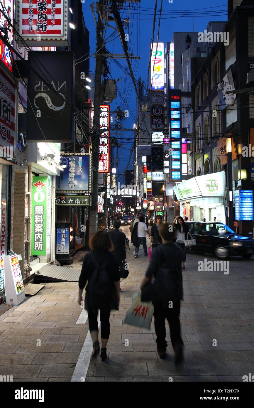 OSAKA, JAPAN - APRIL 25, 2012: Shoppers stroll in Namba area of Osaka ...