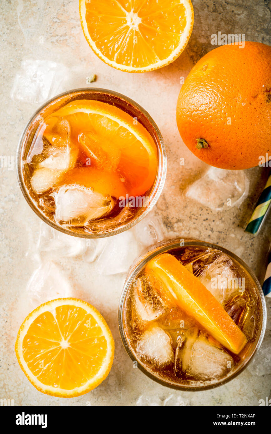 Cold summer cocktail, Iced coffee dink with orange slices, stone table ...
