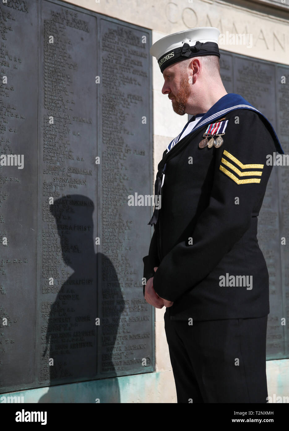 Royal Navy Writer (Submariner) Jamie Martin, looks the names on one of ...