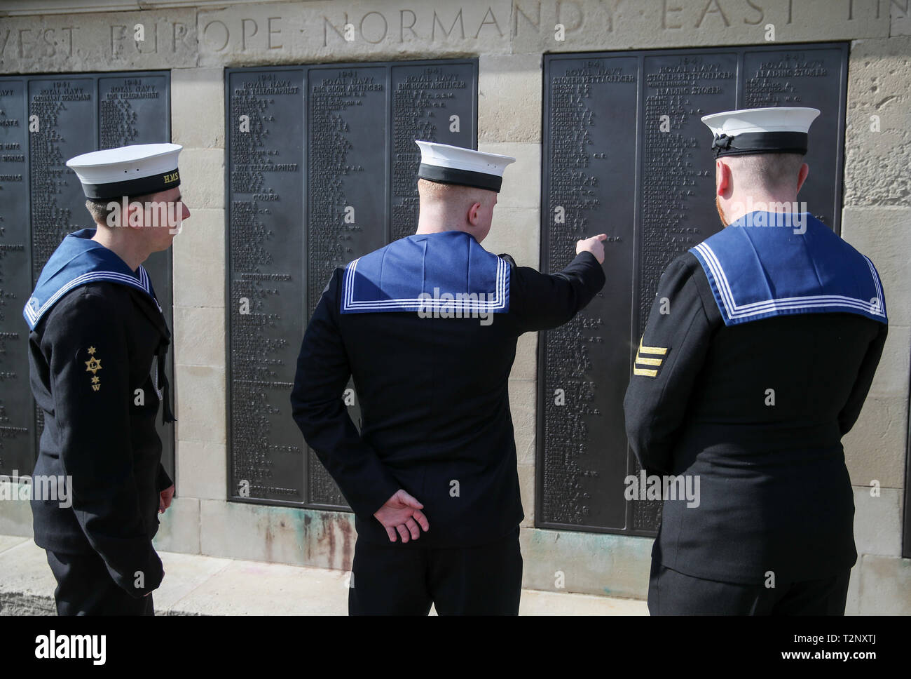 Royal Navy ratings look at the names on one of the panels on the ...