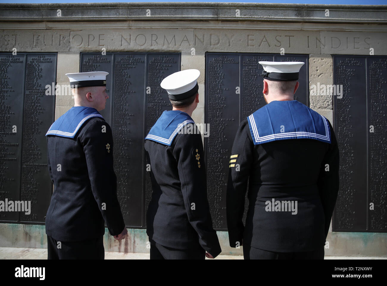 Royal Navy ratings look at the names on one of the panels on the ...