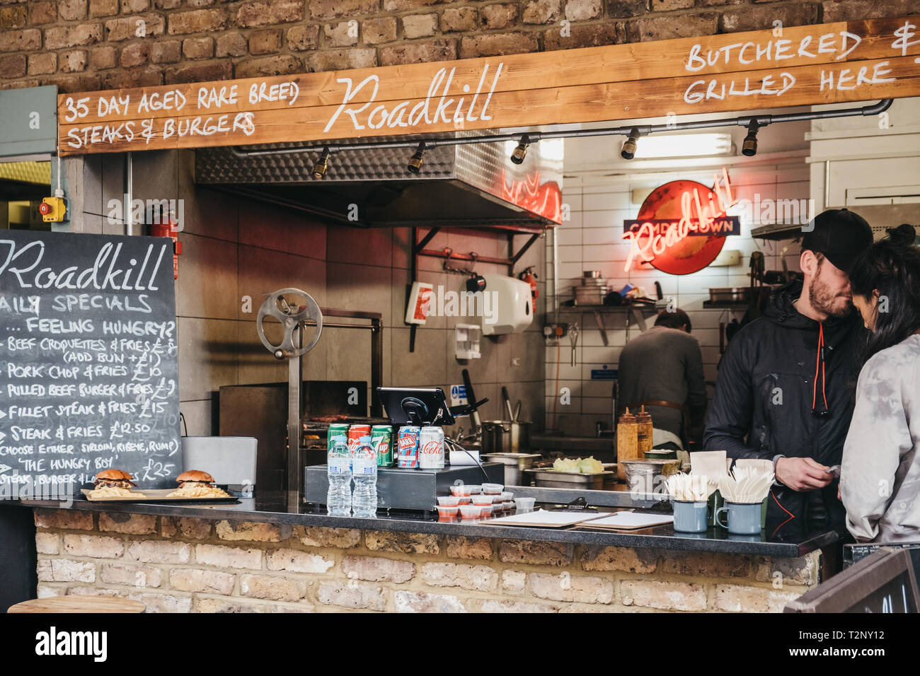London, UK - March 23,2019: Staff at Roadkill street food stand inside ...