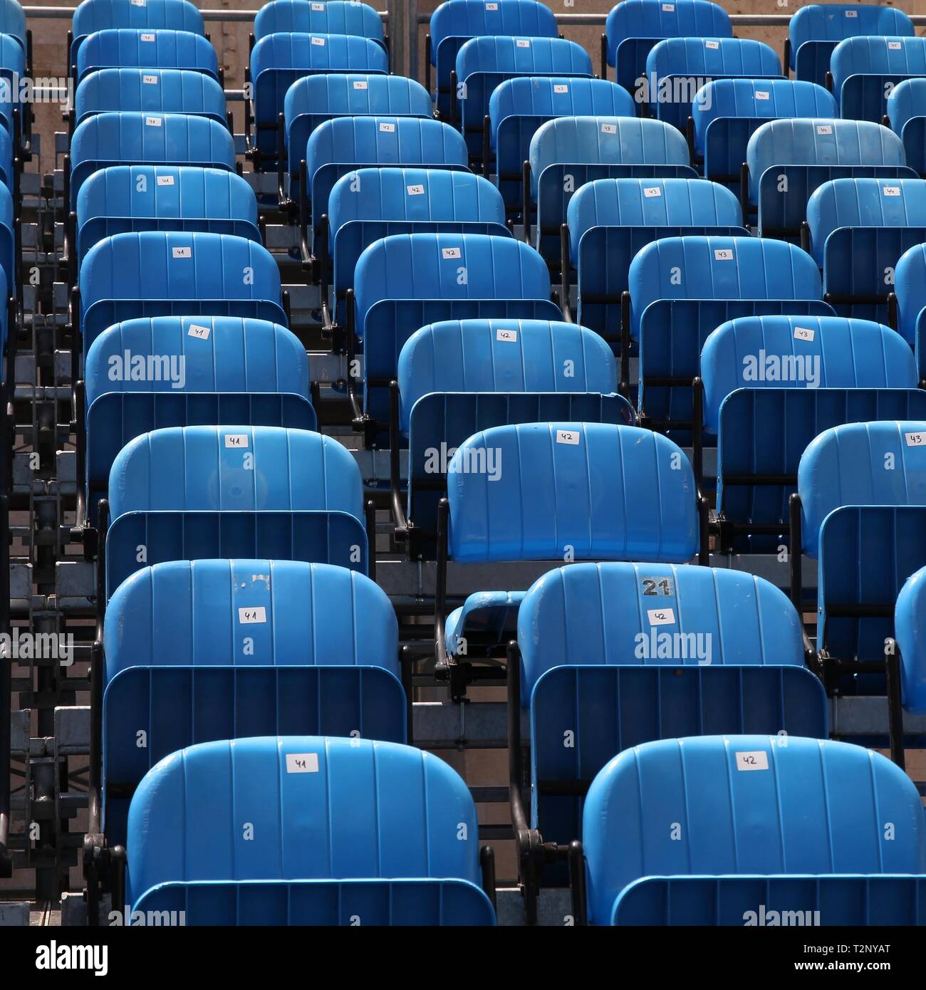 Blue rows of chairs at an outdoor concert. Audience seats. Square ...