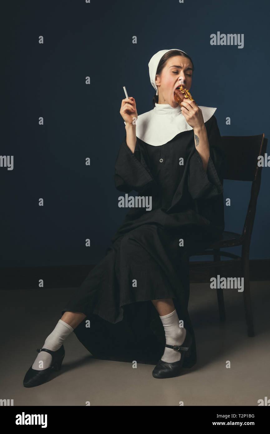 Set yourself free. Medieval young woman as a nun in vintage clothing ...