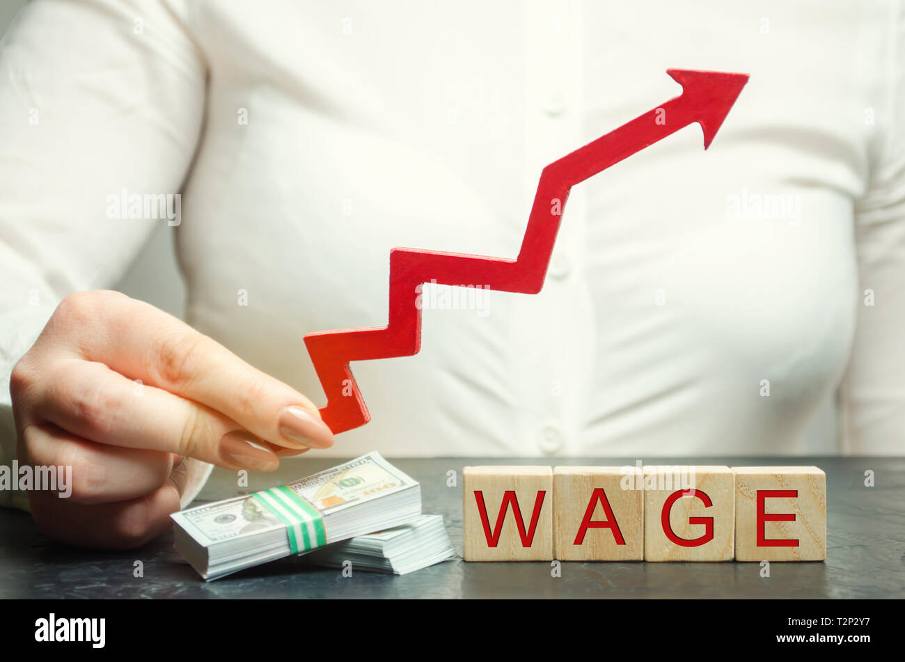 Female hand holds arrow up above word wage. Increase of salary, wage ...
