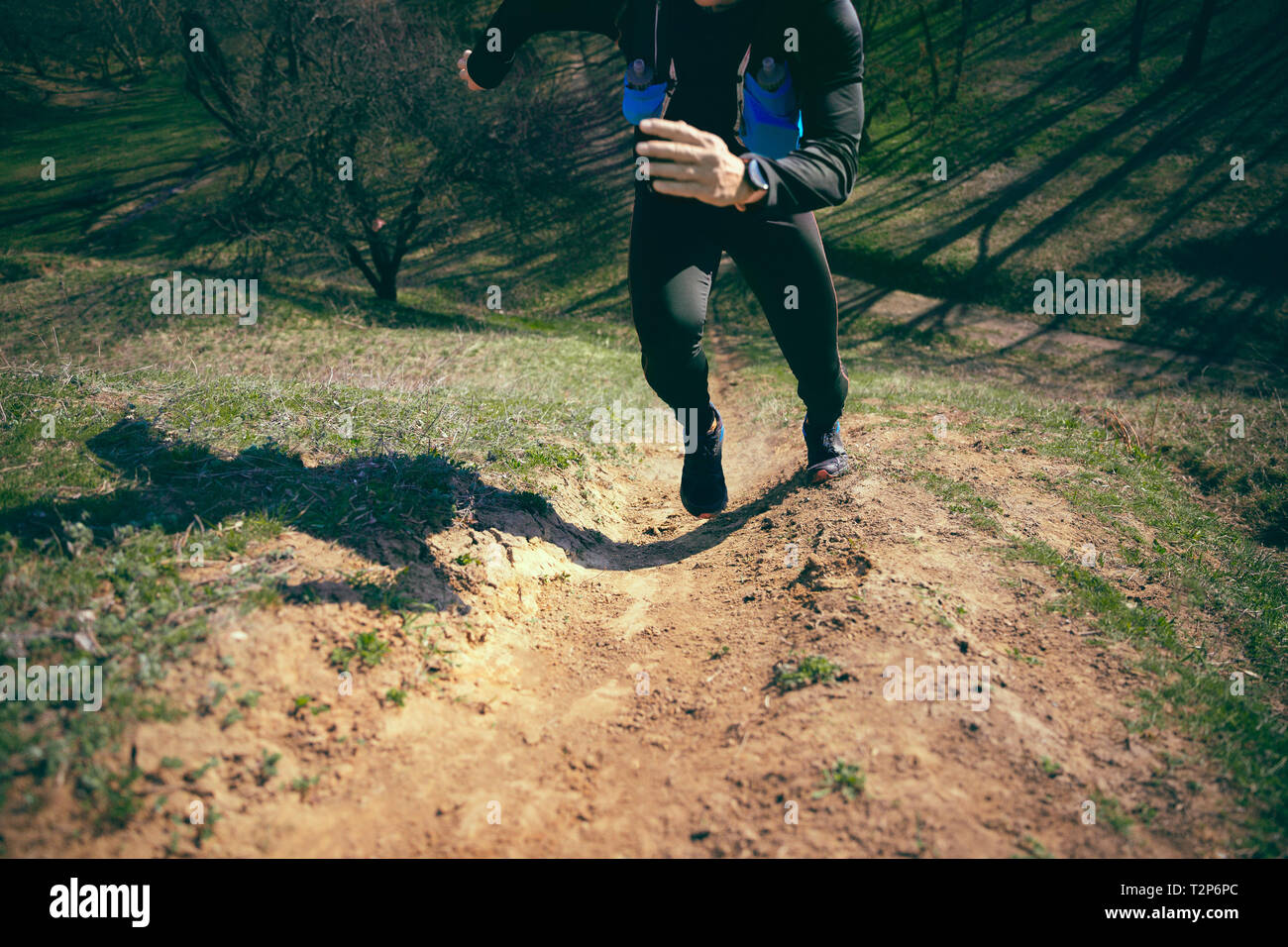 Springtime and jogging. Young man running at forest. Athlete crossing ...