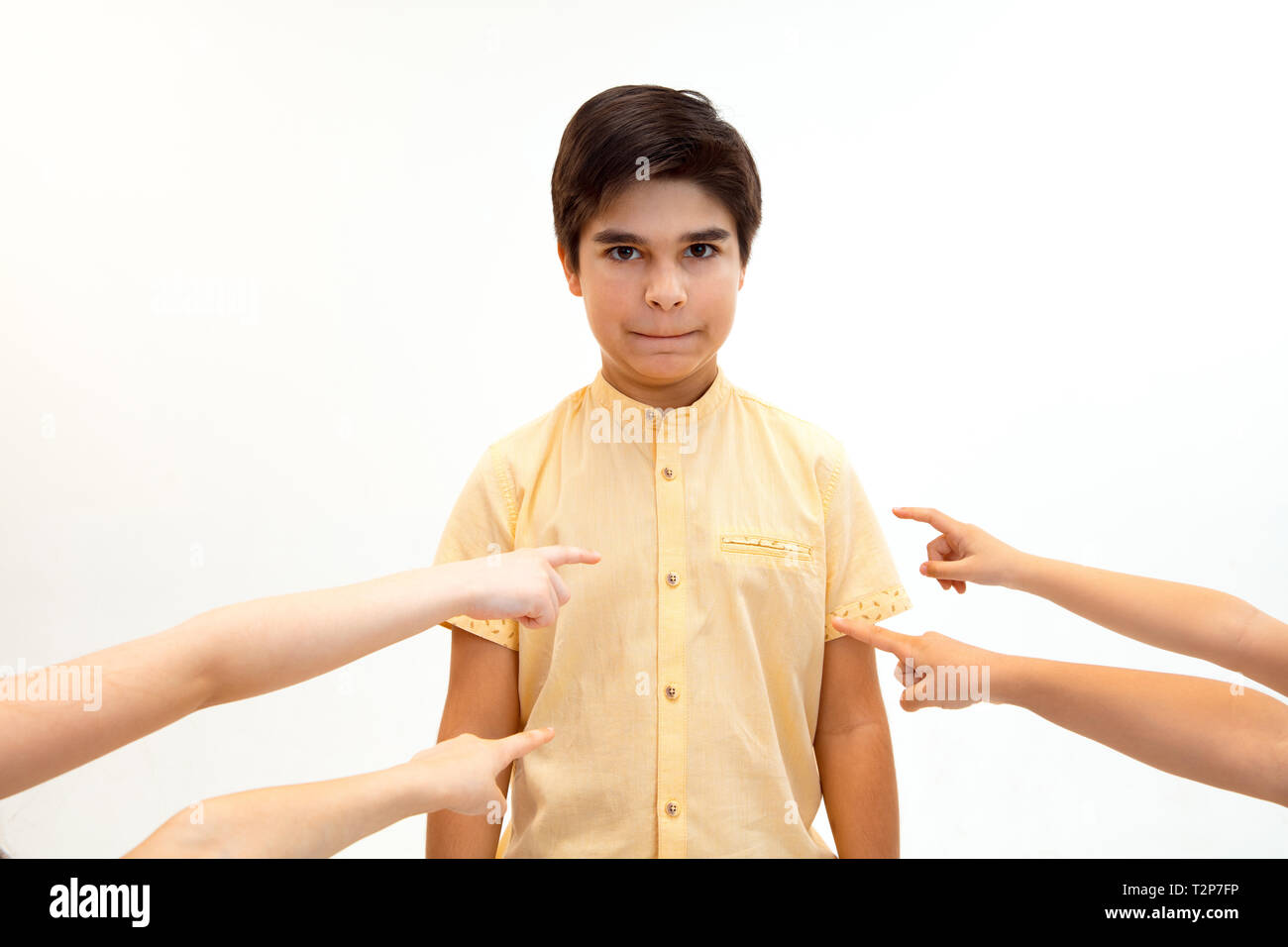 Little boy standing alone and suffering an act of bullying while ...