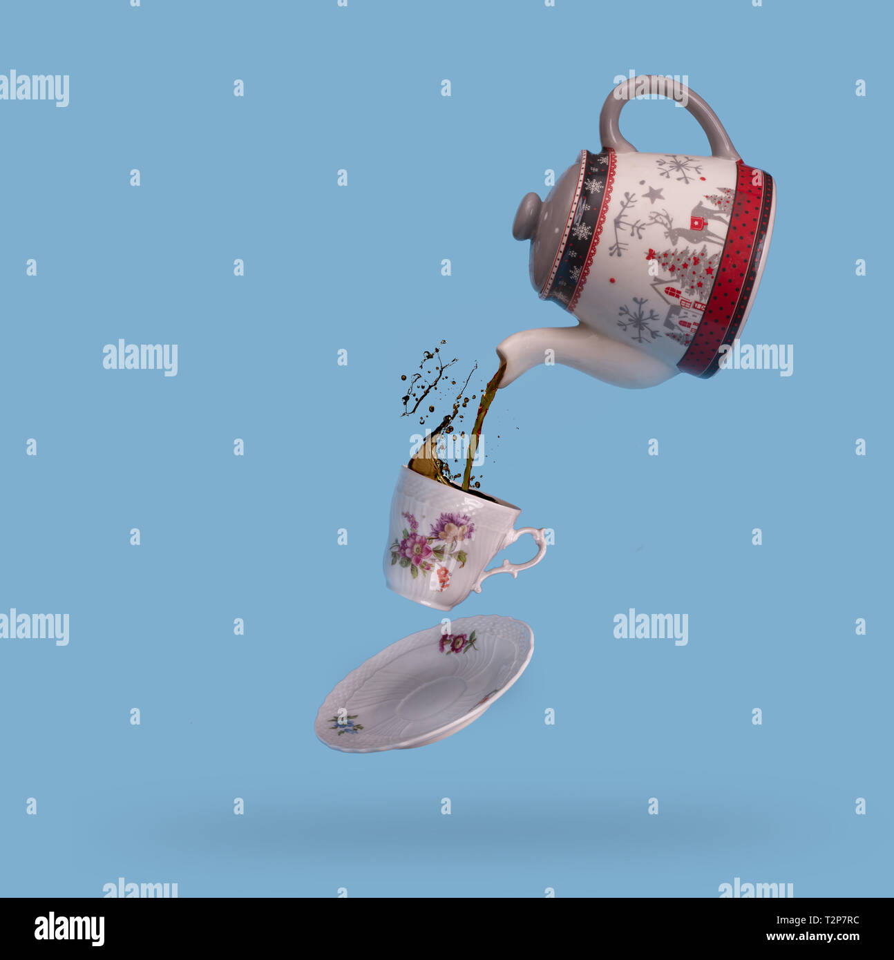still image of a teapot pouring tea into a cup that is falling into the ...