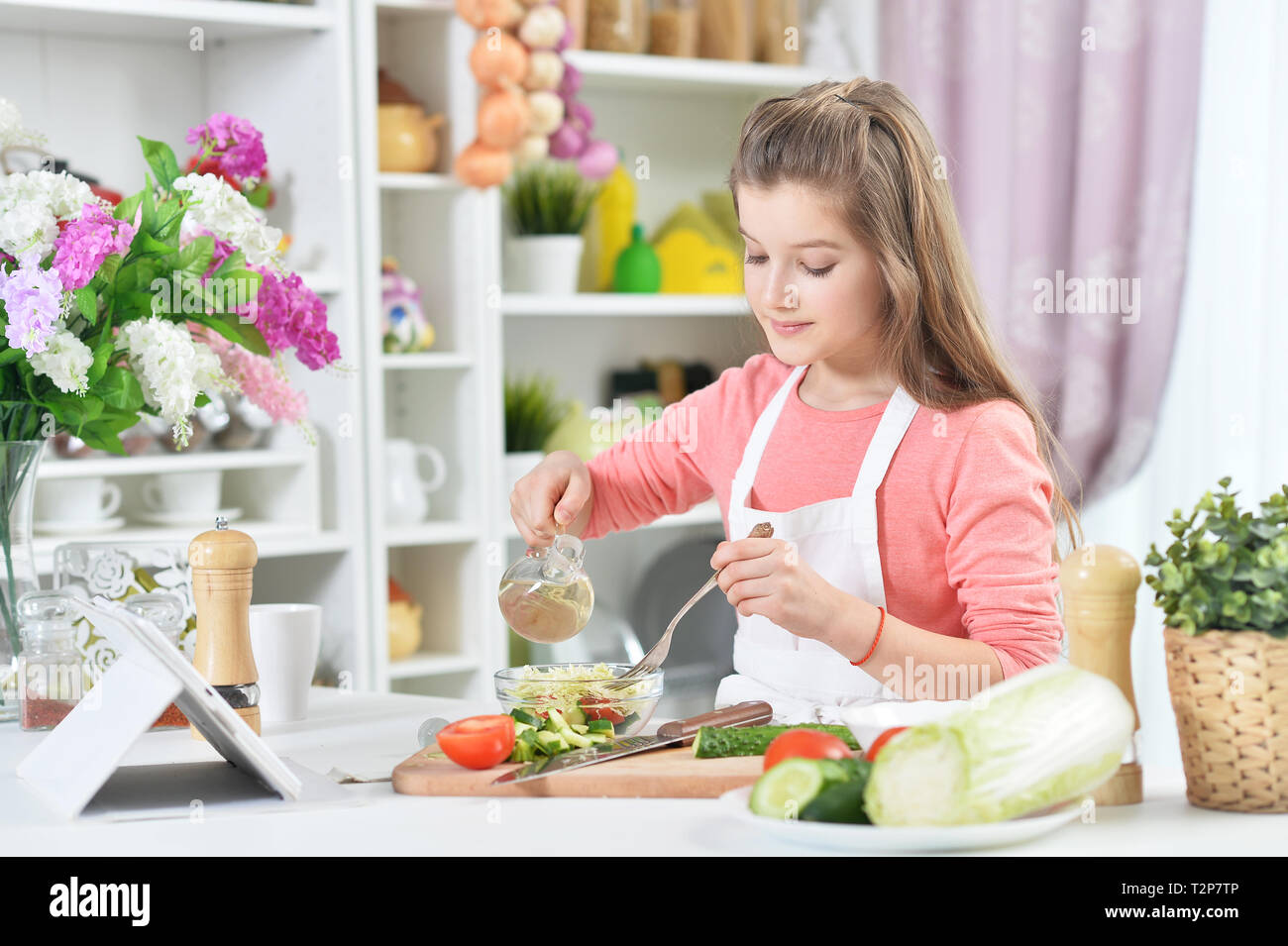 attractive young girl cooking in the kitchen Stock Photo - Alamy