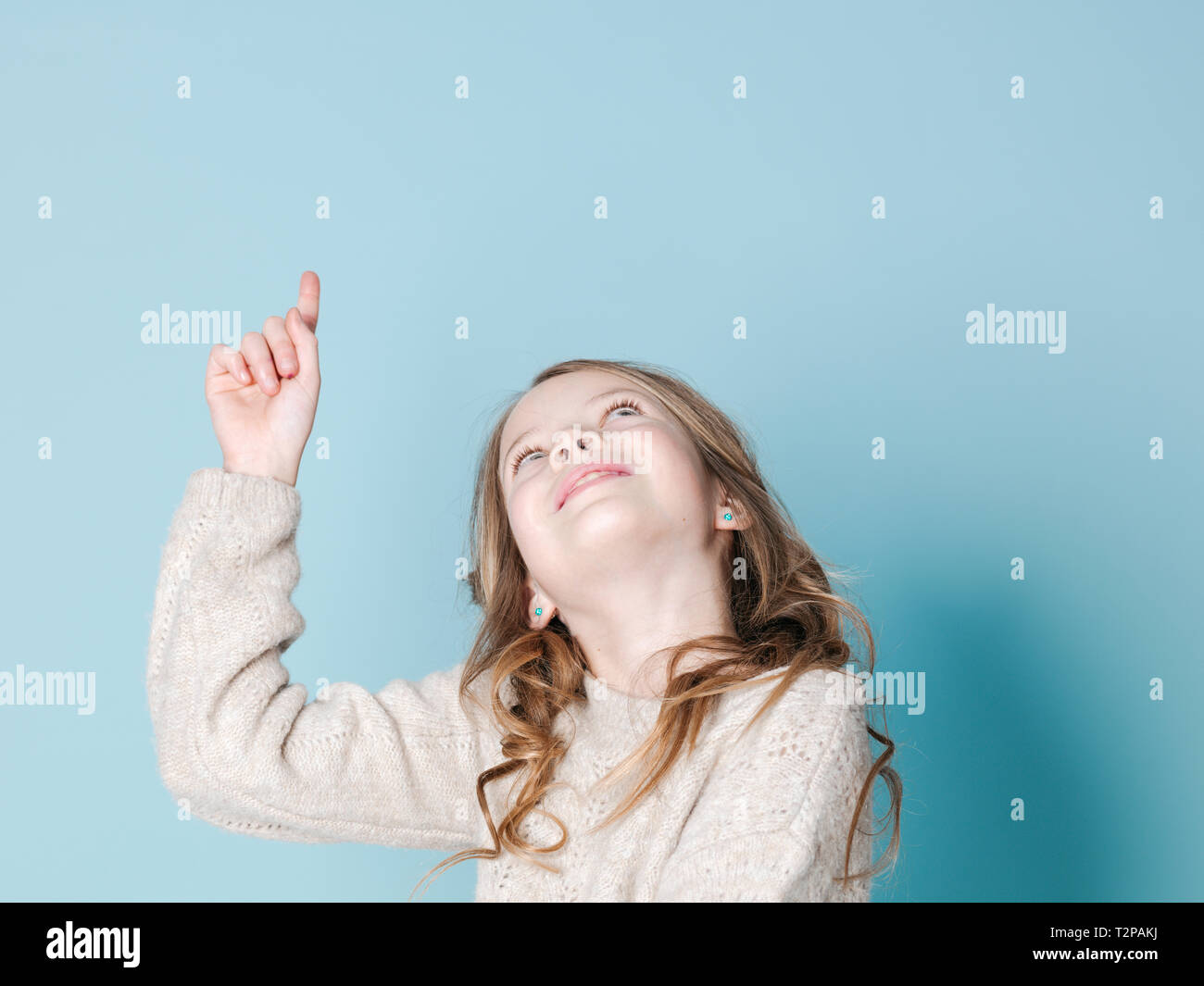 pretty and cool 9 year old girl with brown wool sweater posing in front ...