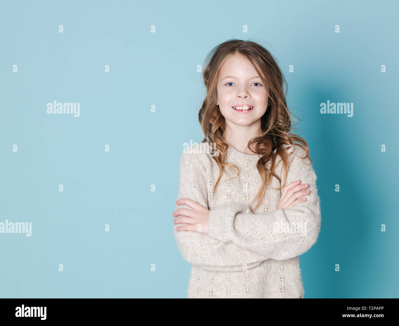 pretty and cool 9 year old girl with brown wool sweater posing in front ...