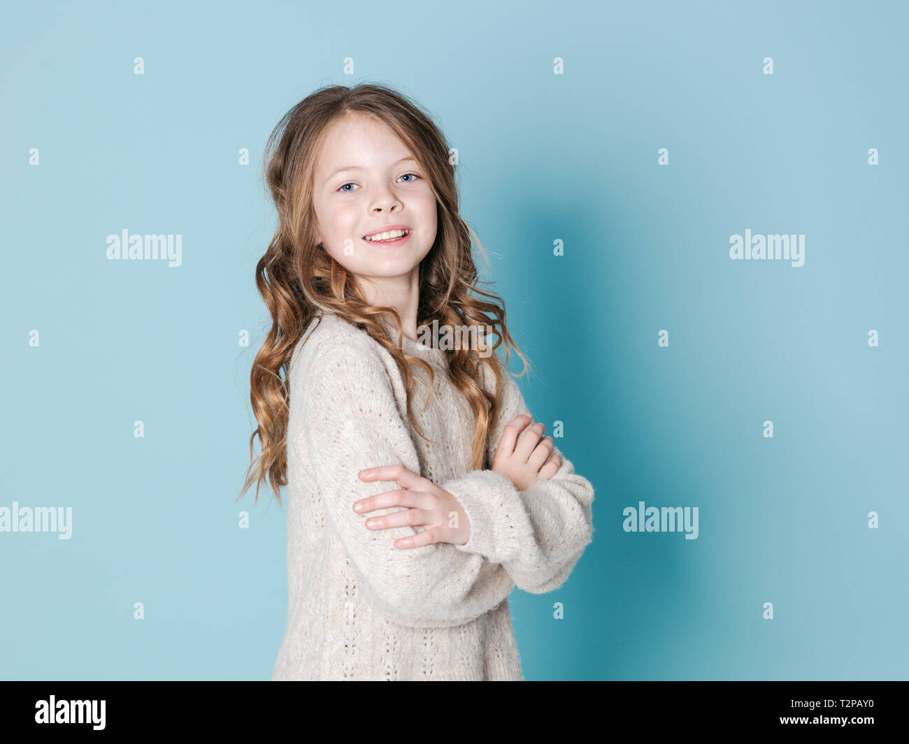 pretty and cool 9 year old girl with brown wool sweater posing in front ...