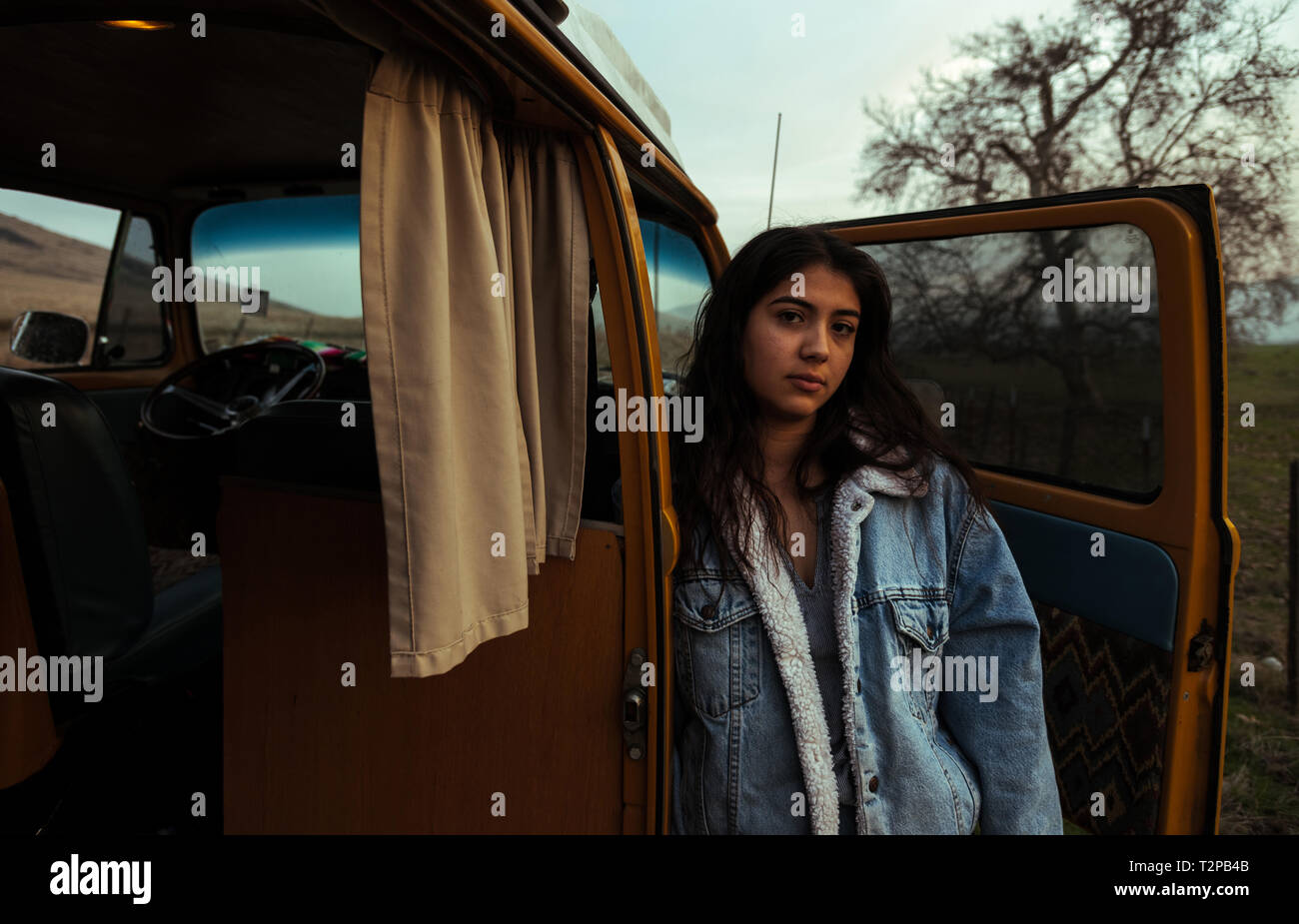 Young woman stopping on roadside Stock Photo - Alamy