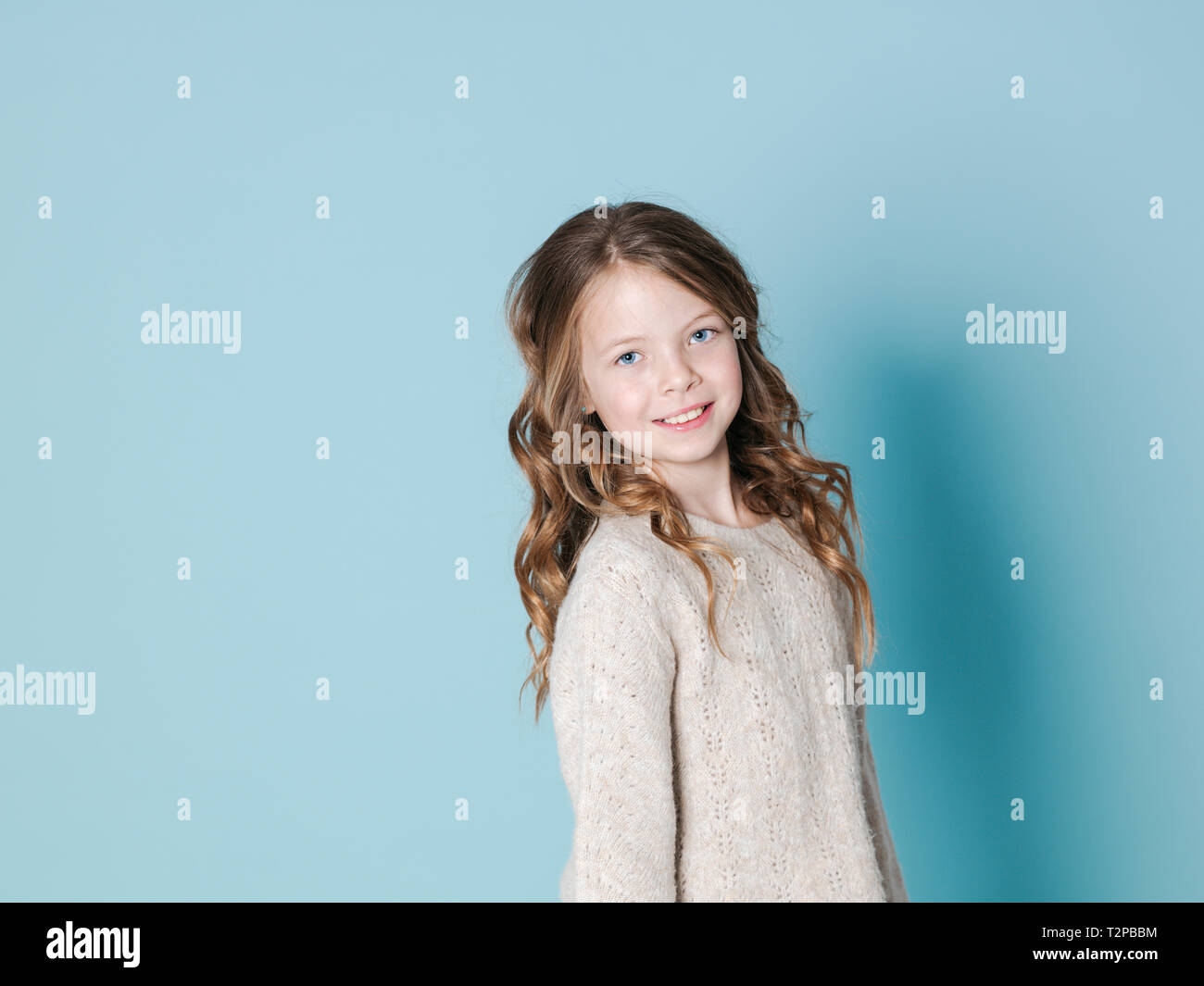 pretty and cool 9 year old girl with brown wool sweater posing in front ...
