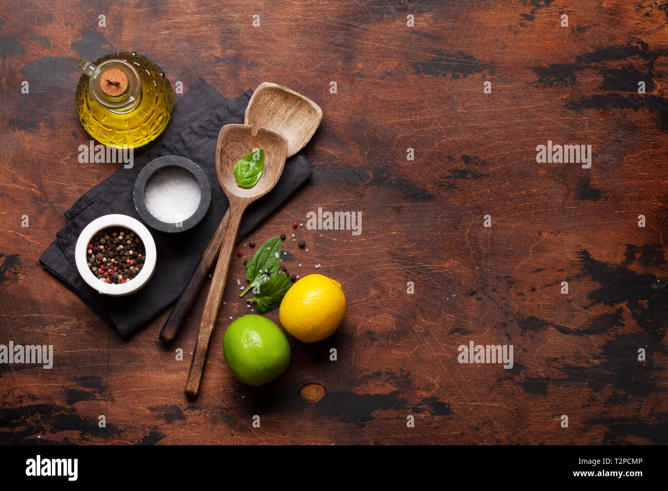 Cooking wooden utensils, condiments and spices on wooden kitchen table ...
