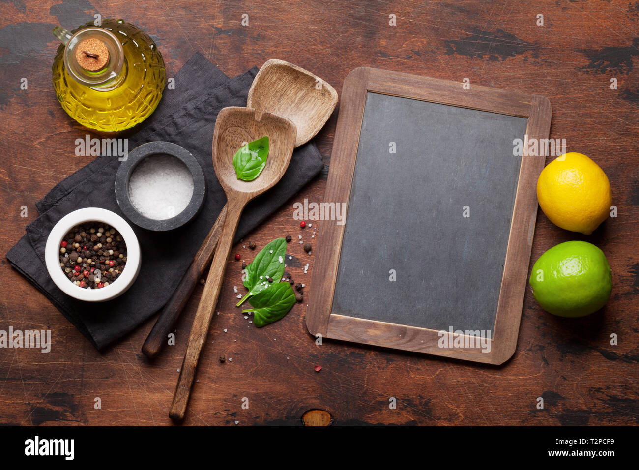 Cooking wooden utensils, condiments and spices on wooden kitchen table ...