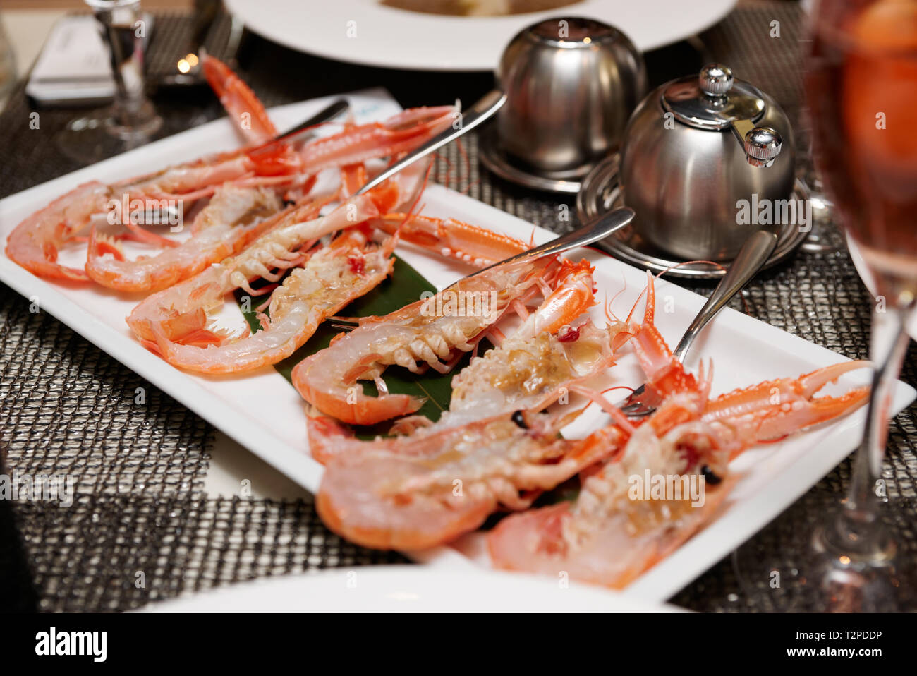Raw scampi dish on restaurant table - tasty seafood Stock Photo - Alamy