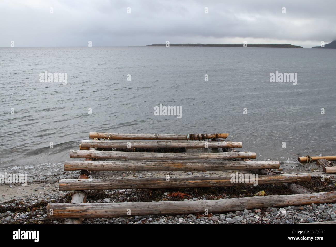 Homemade log ramps for sliding boats into water Stock Photo - Alamy