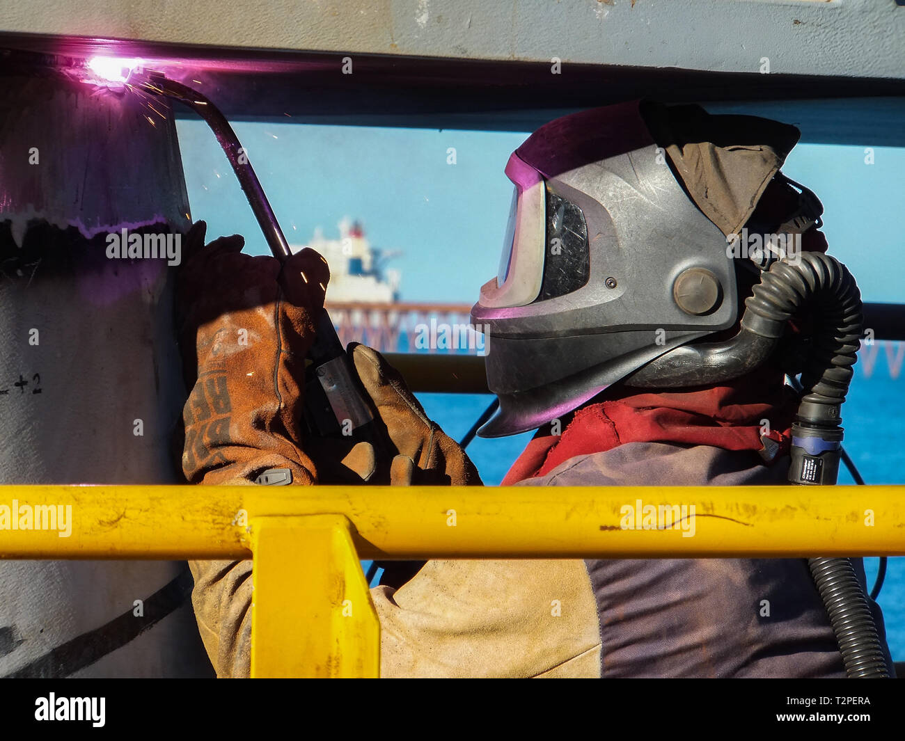 A welder with all of the correct protective equipment safely welds a ...