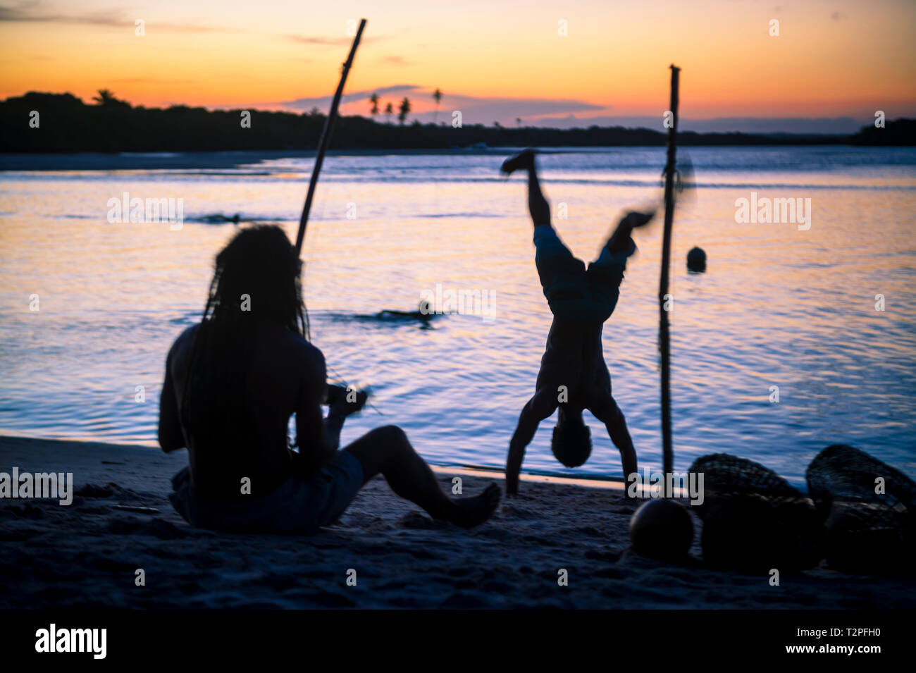 Scenic sunset silhouettes performing capoeira, the Afro-Brazilian ...