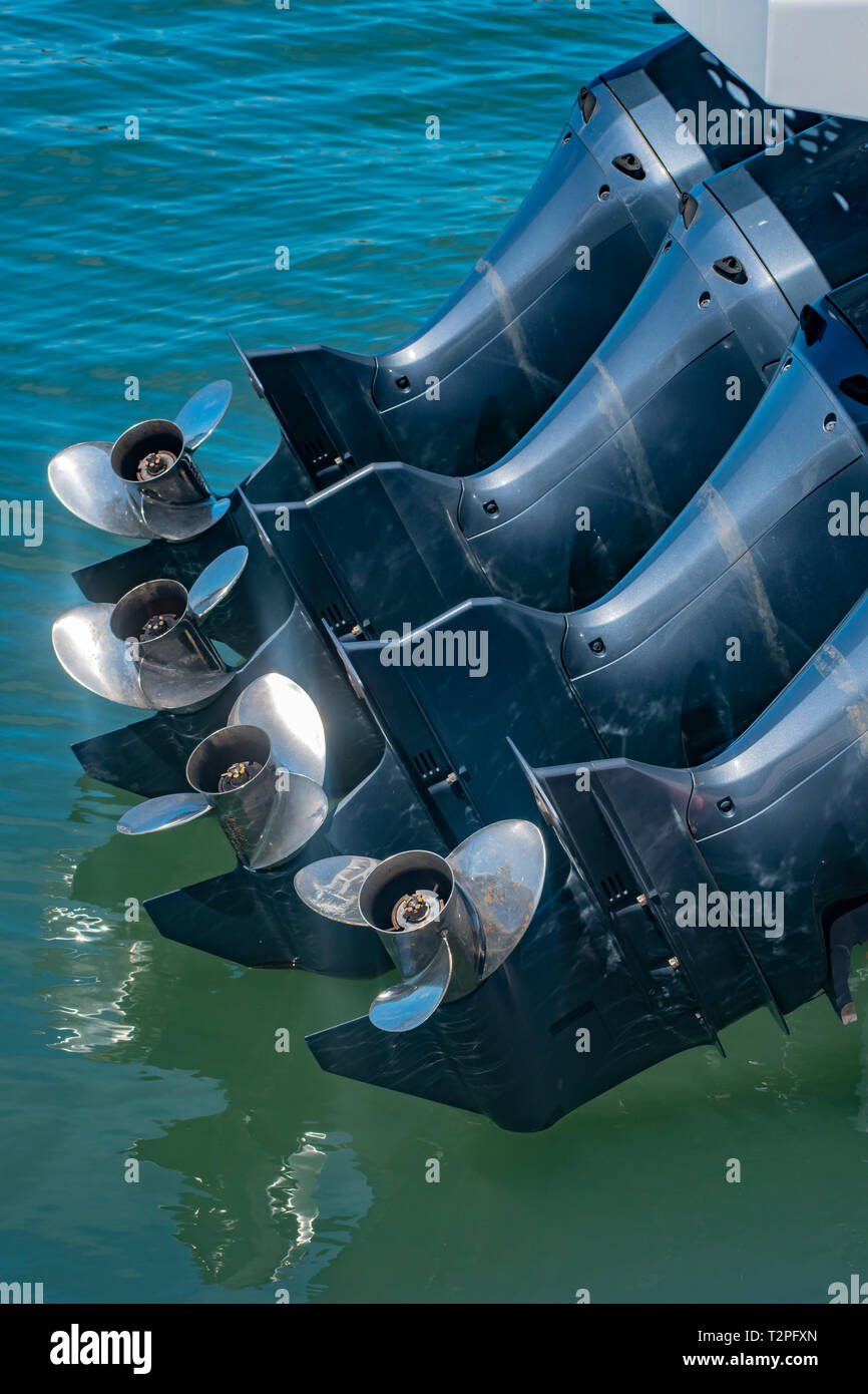 The hull of a boat with 4 powerful propellor engines out of the water ...
