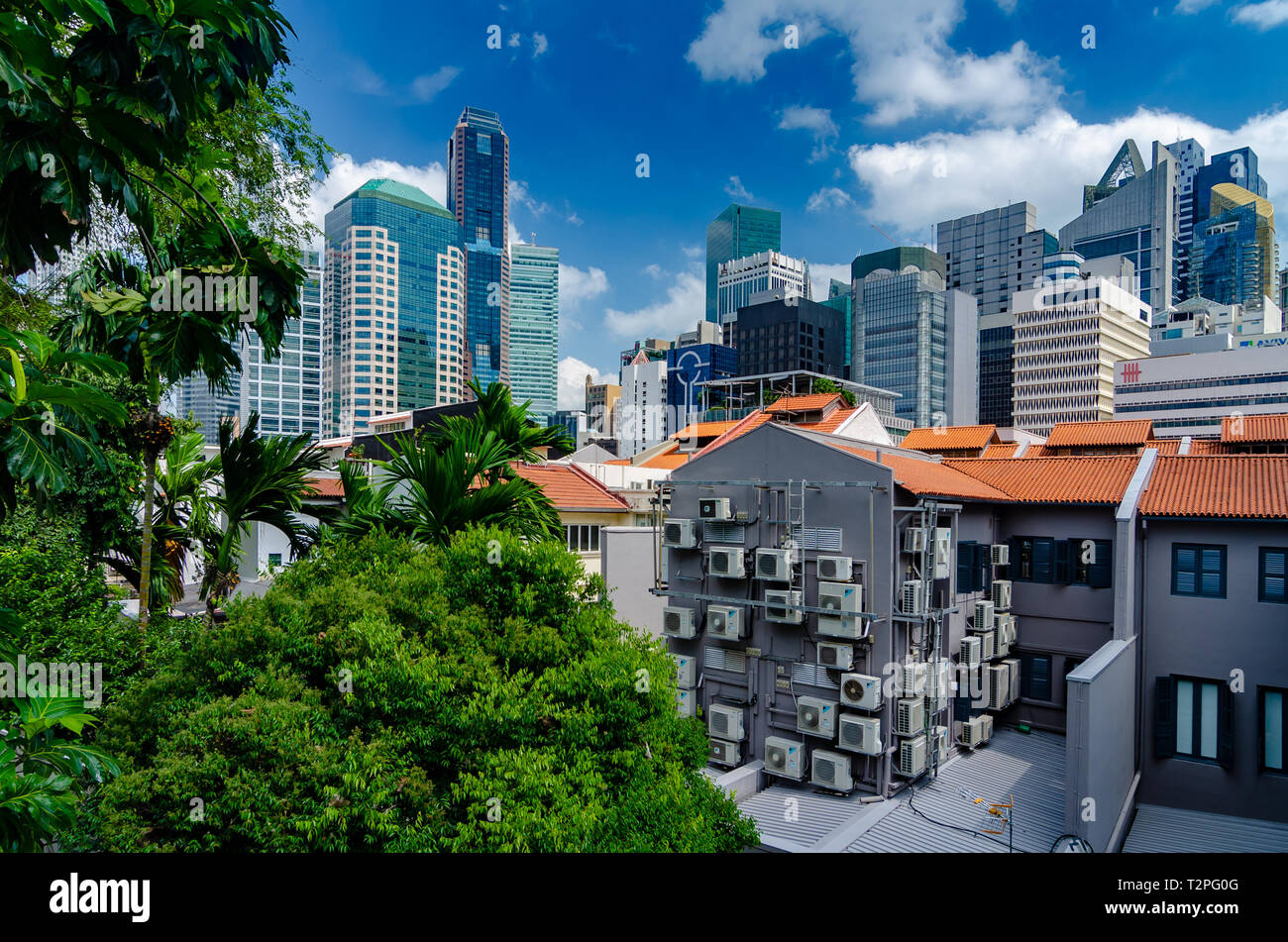 A residential building with many air-conditioners is dwarfed by the ...
