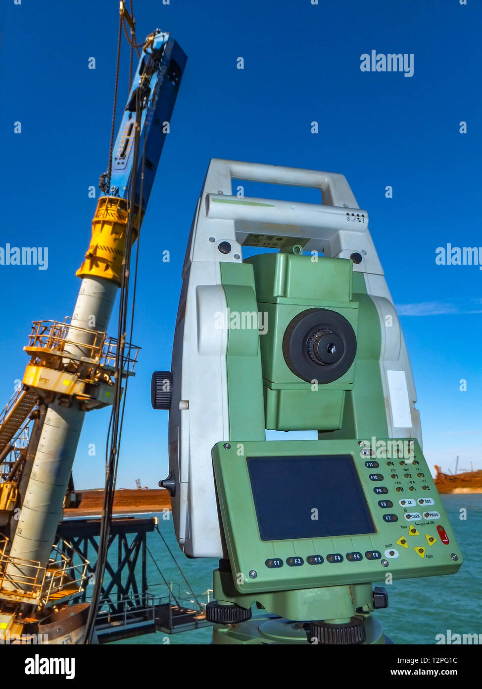 A raked pile for a wharf construction project is hammered into the ...