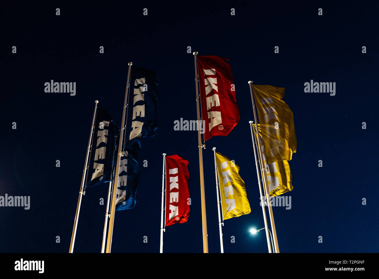 RIGA, LATVIA - APRIL 3, 2019: IKEA flags during dark evening and wind ... RIGA, LATVIA - APRIL 3, 2019: IKEA flags during dark evening and wind ...