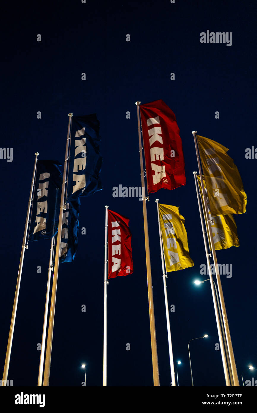 RIGA, LATVIA - APRIL 3, 2019: IKEA flags during dark evening and wind ... RIGA, LATVIA - APRIL 3, 2019: IKEA flags during dark evening and wind ...