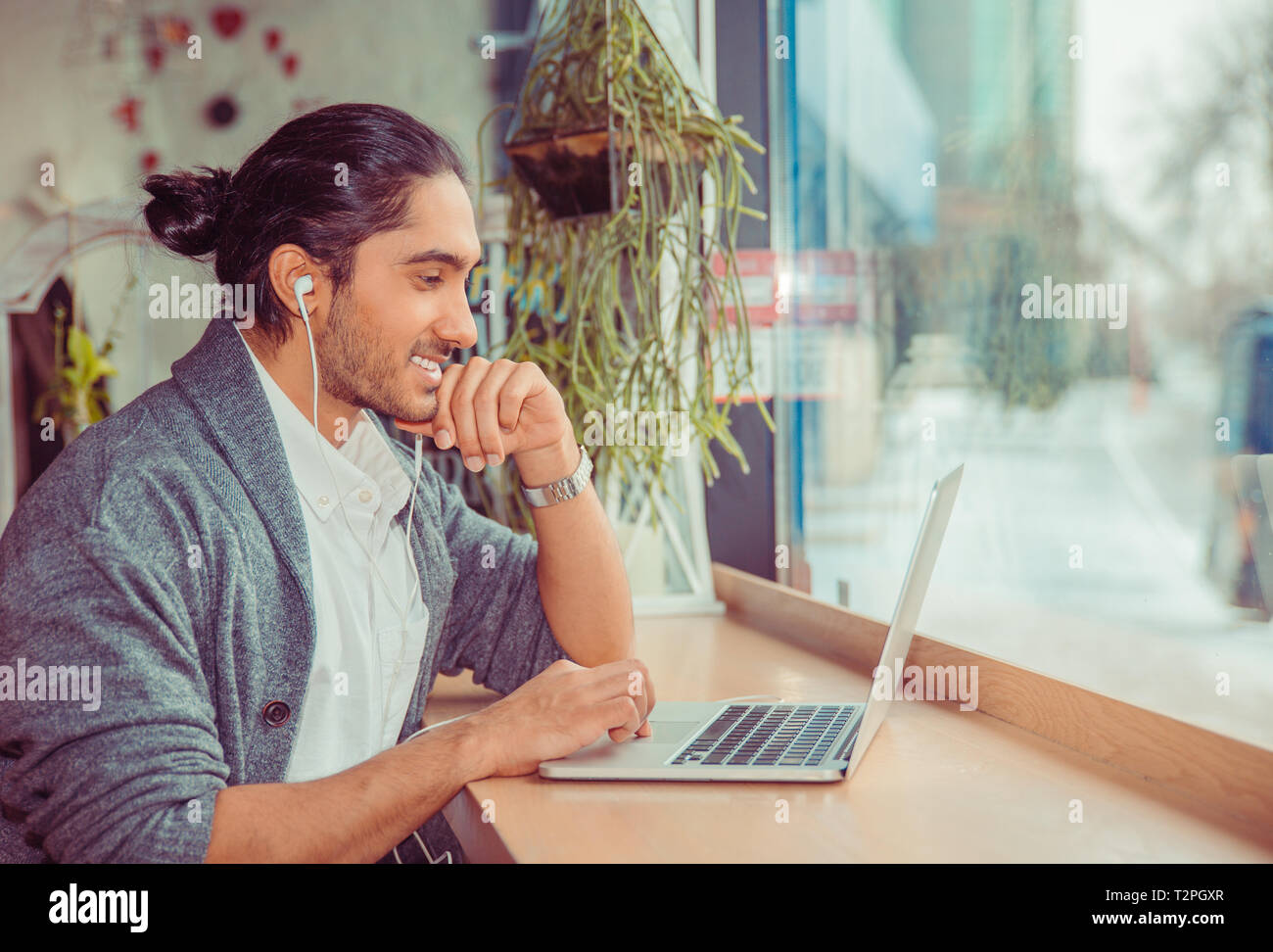 Man in earphones looking at the computer smiling happy. Closeup ...
