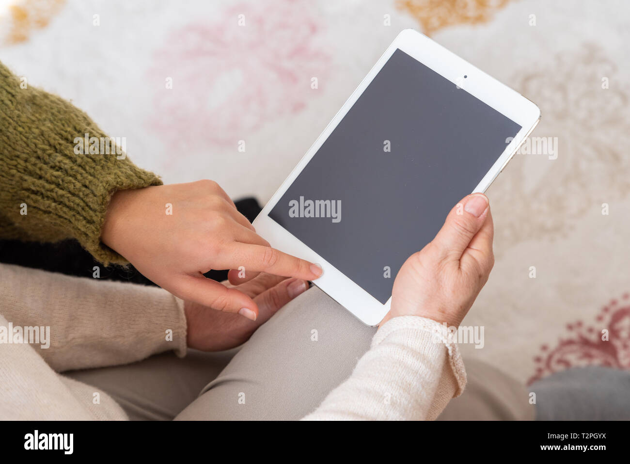 Adult woman and daughter using tablet with blank screen Stock Photo - Alamy