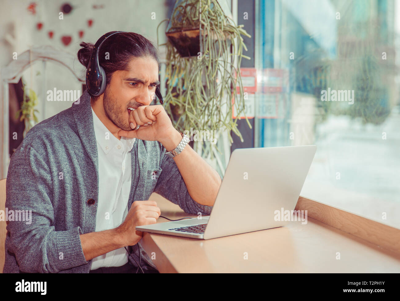 Nervous customer service representative biting fist while talking to ...