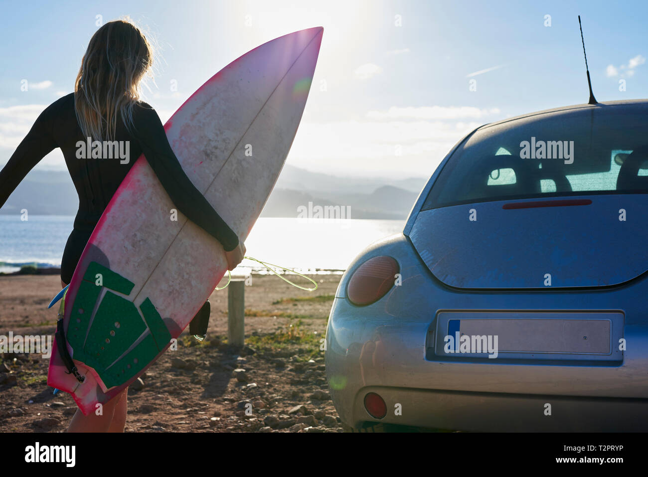 Surfer with surfboard on beach Stock Photo - Alamy