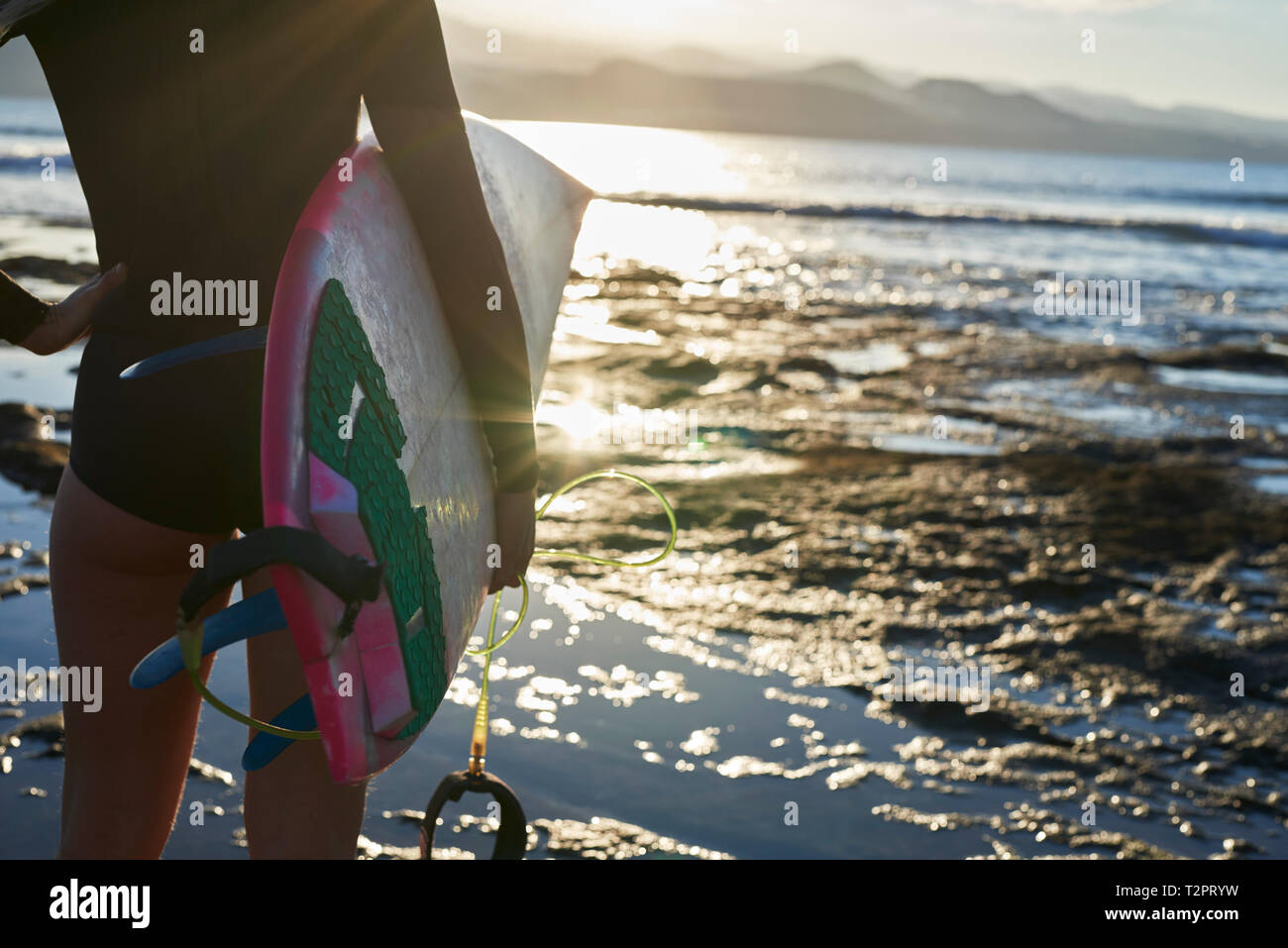 Surfer with surfboard on beach Stock Photo - Alamy