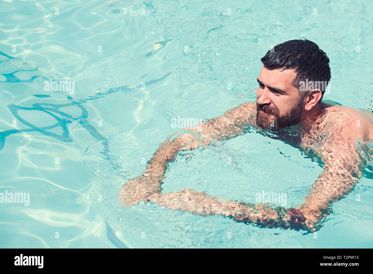 bearded man swimming in blue water. Summer vacation and travel to ocean ...