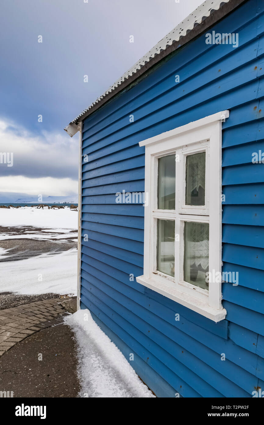 A classic blue house in Ísafjörður, located along the large fjord known ...