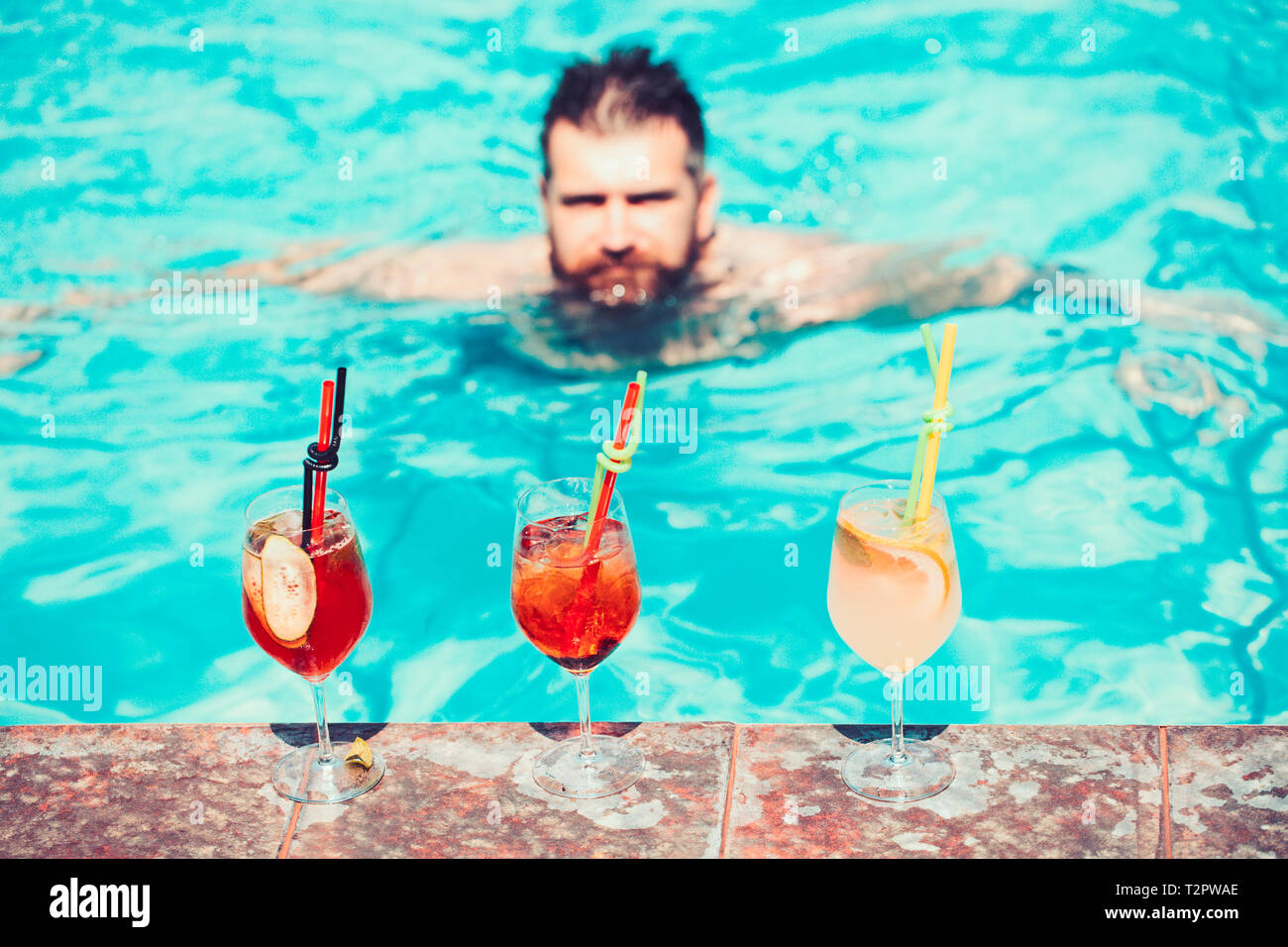 Happy man drink cocktail at the pool. Summer holiday idyllic Stock ...