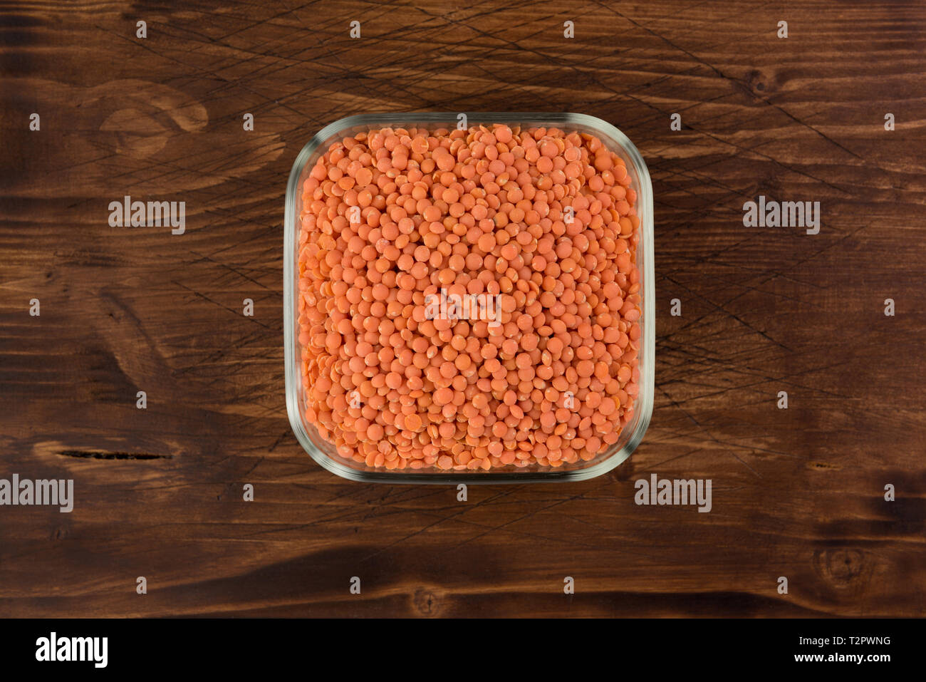 Red lentils in glass plate on wooden table background Stock Photo - Alamy
