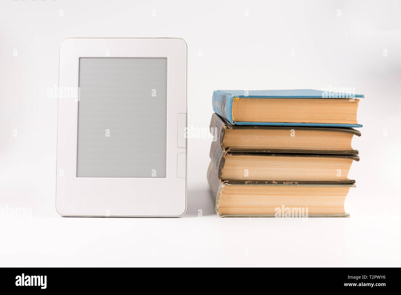 Electronic book with stack of regular old books isolated on white ...