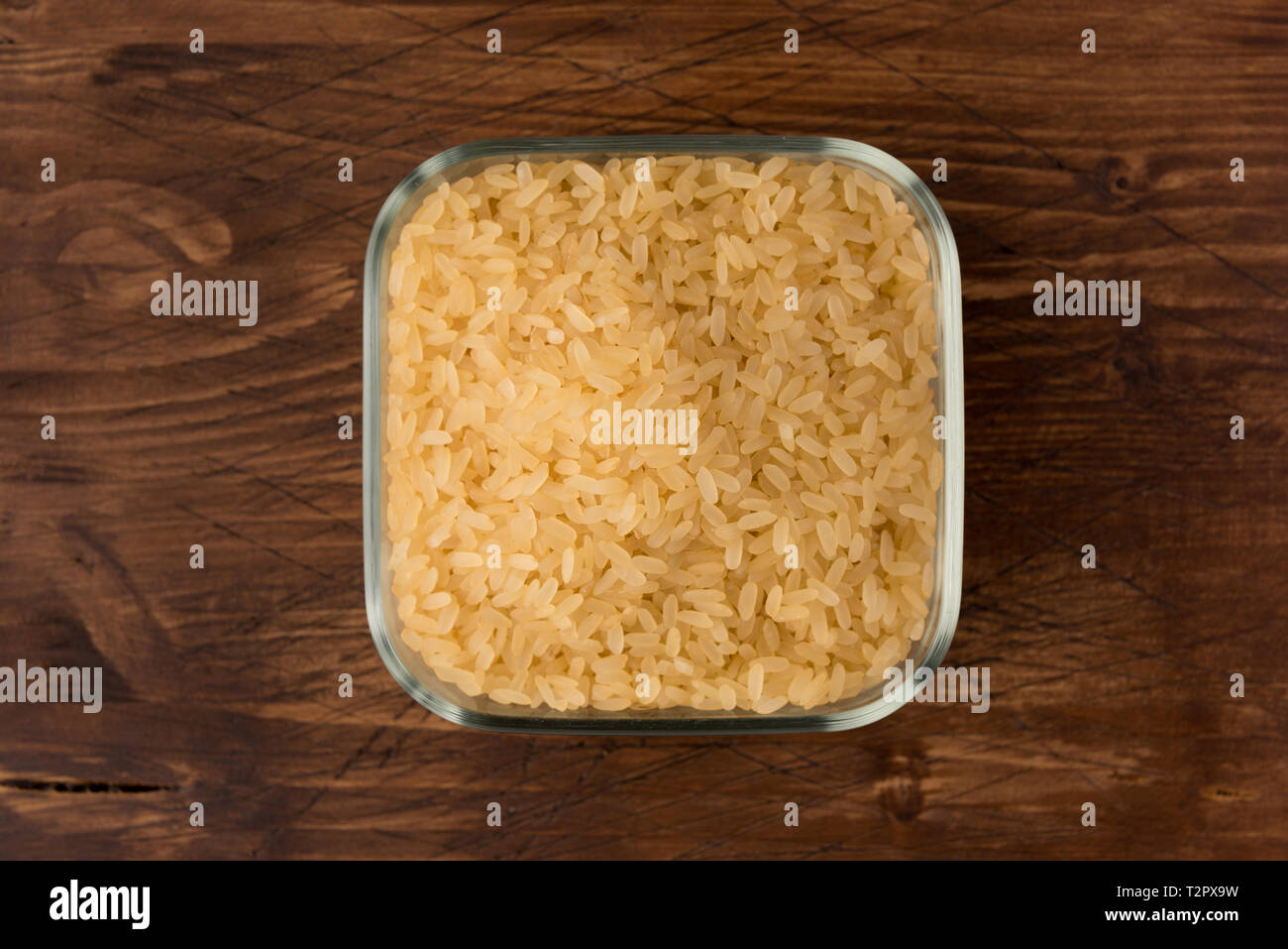 white rice in bowl on wooden table background Stock Photo - Alamy