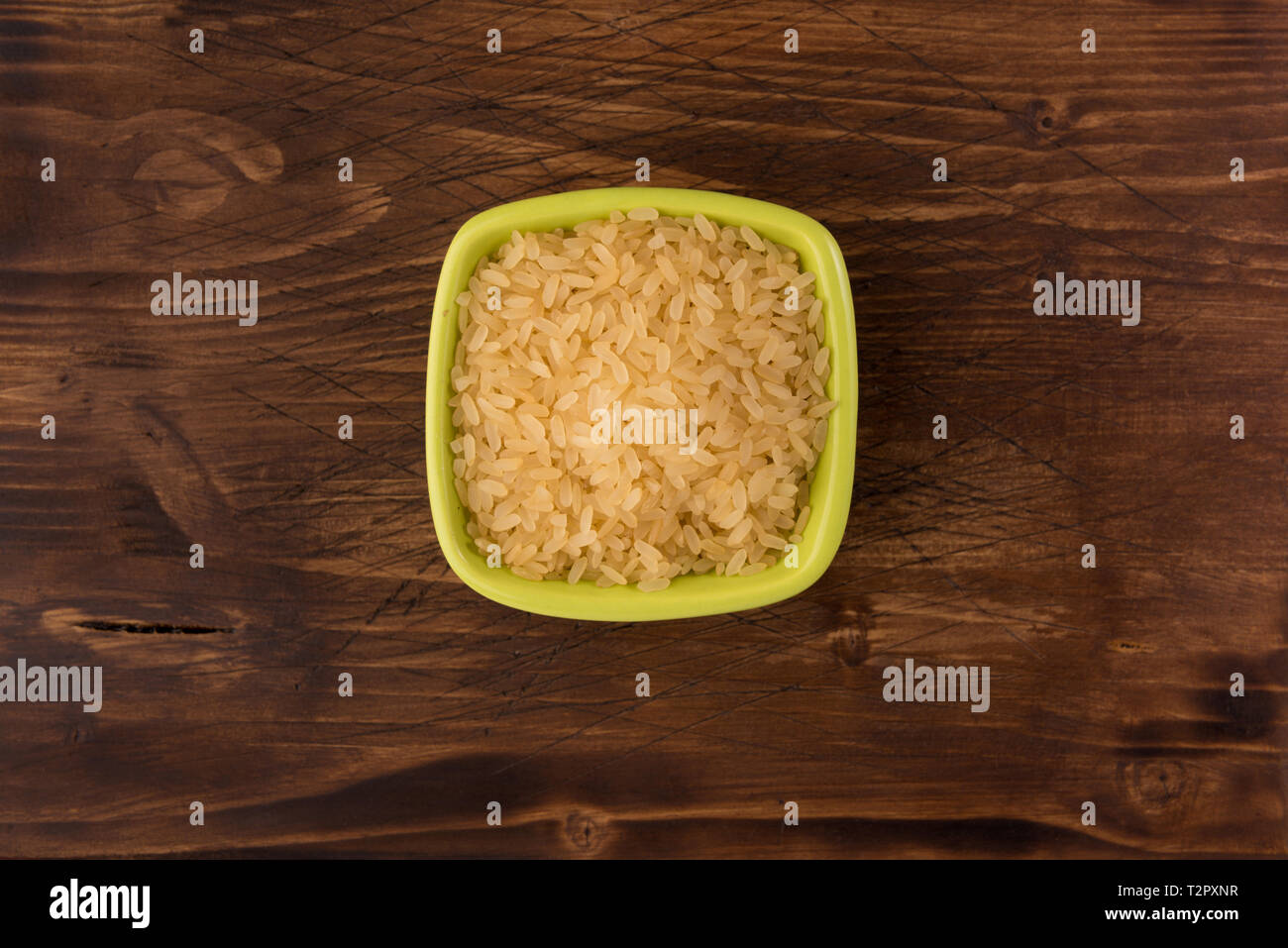 white rice in bowl on wooden table background Stock Photo - Alamy