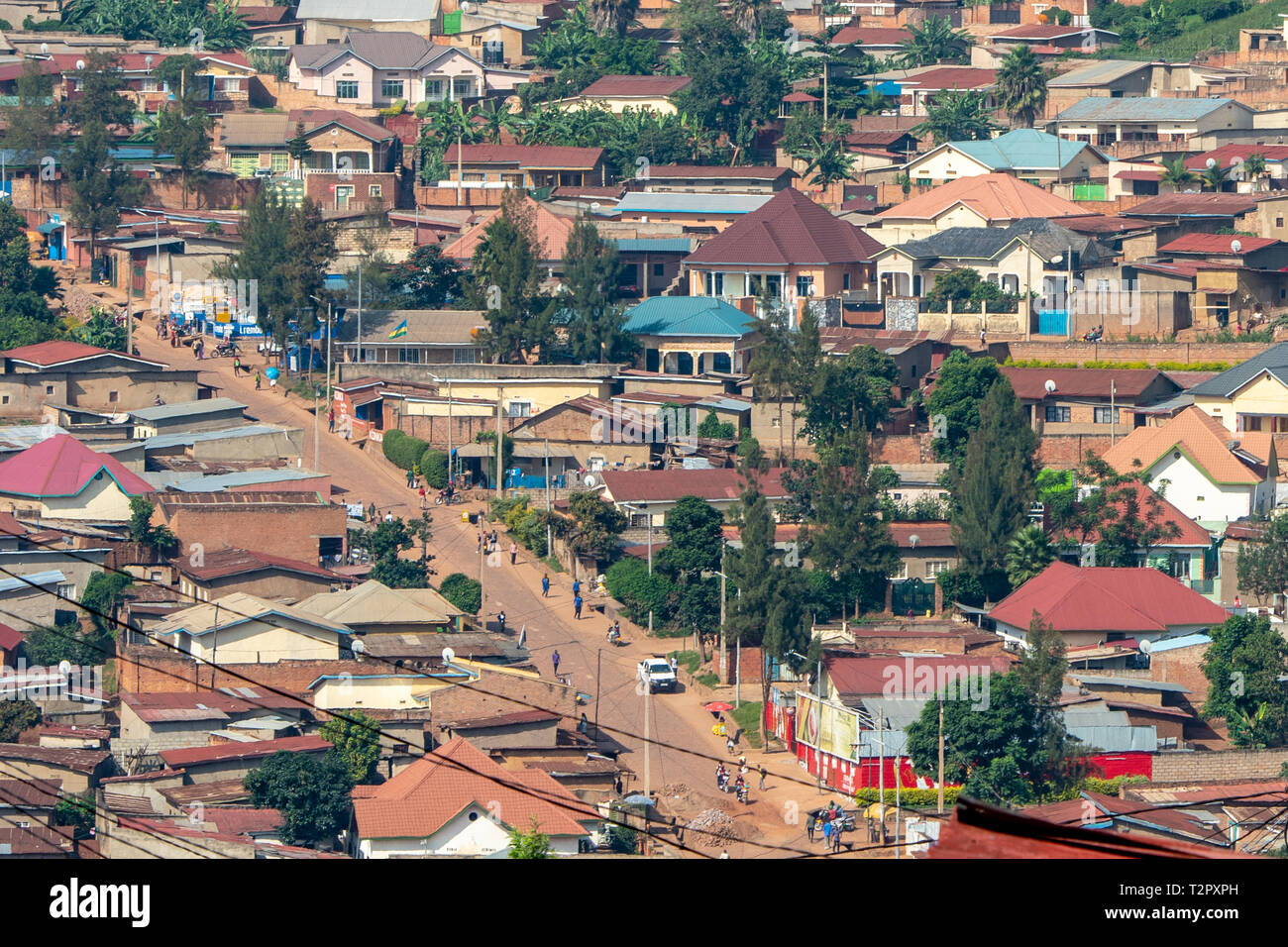 Houses sprawl across a crowded hillside in Kigali, the capital city of ...