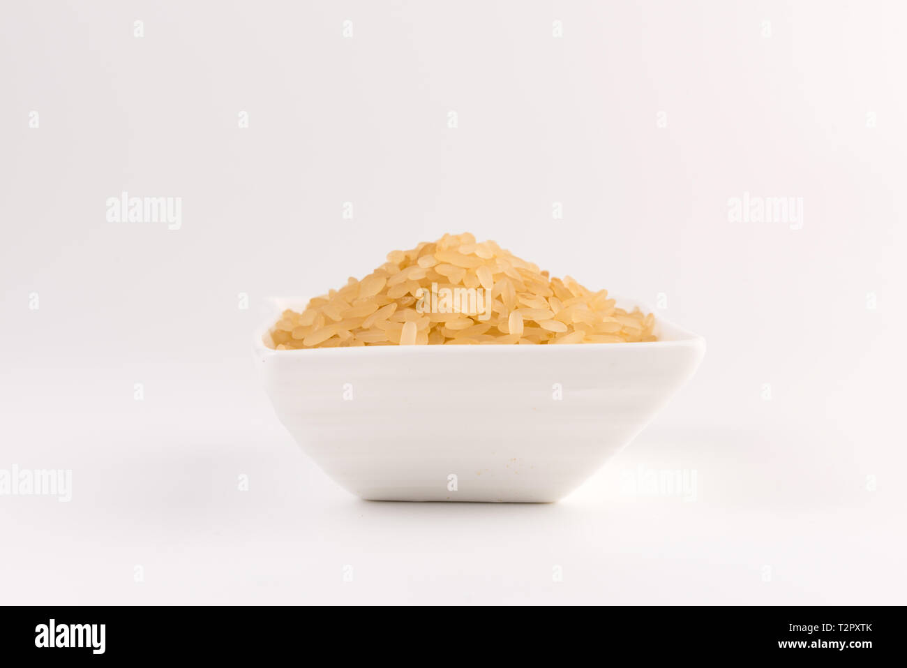 white rice in bowl isolated on white background Stock Photo - Alamy