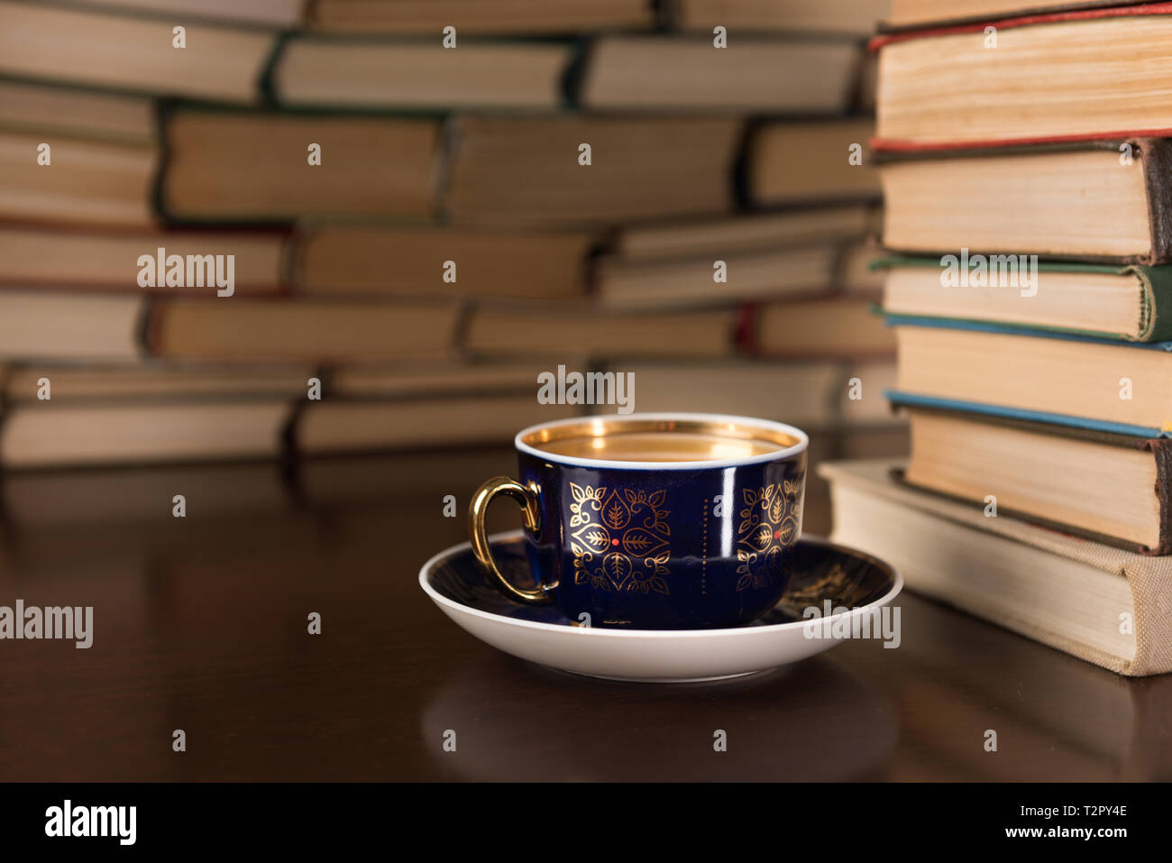 cup of tea and many books on the desktop Stock Photo - Alamy
