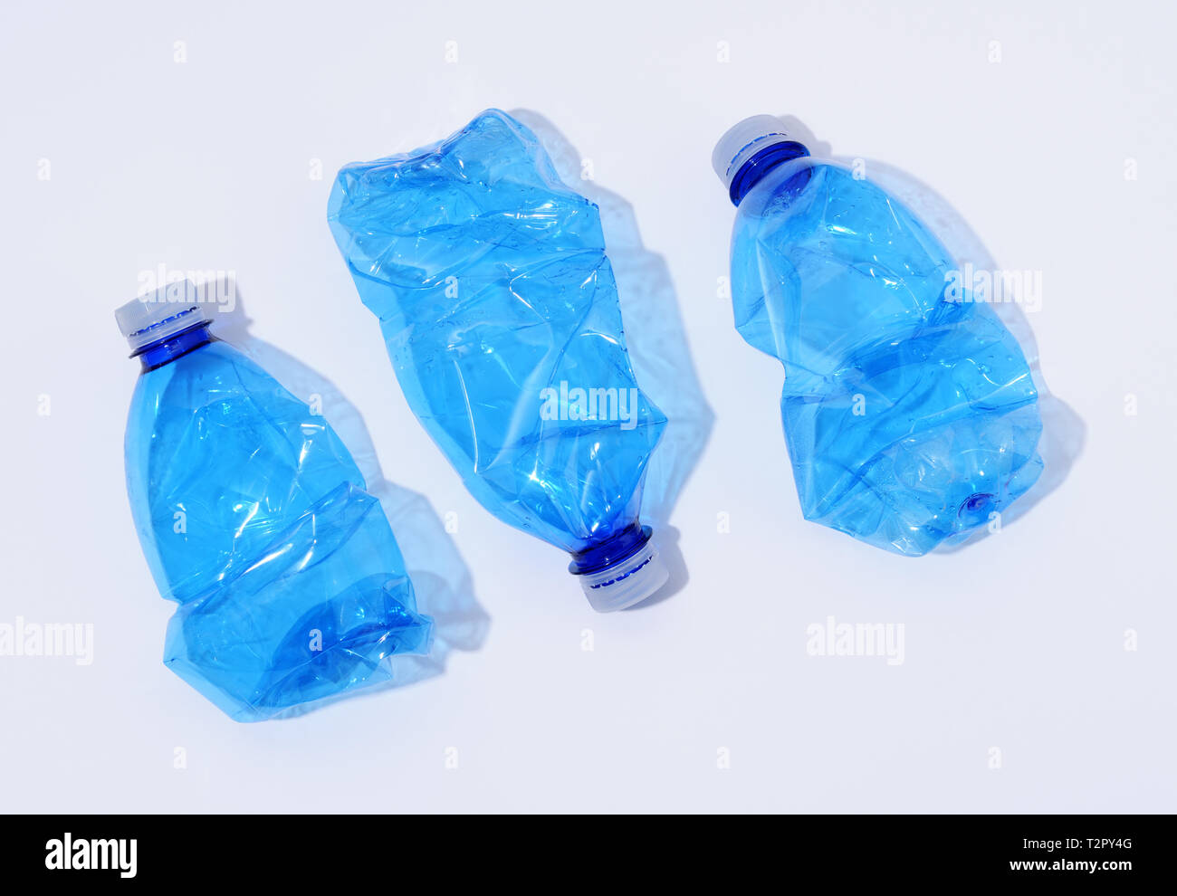 arrangement of blue plastic bottles on white background Stock Photo - Alamy