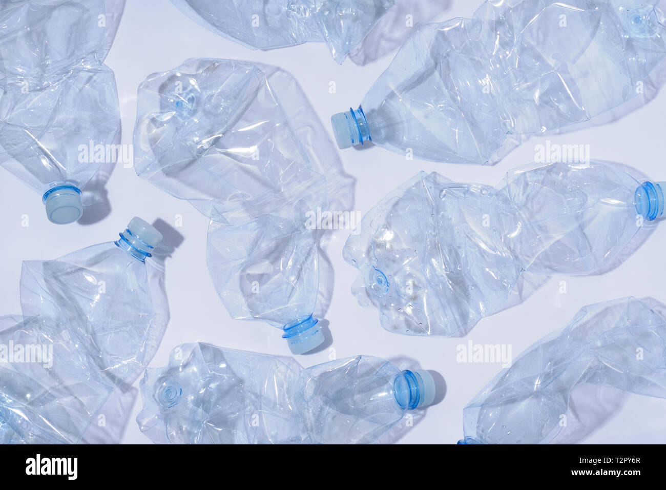 arrangement of blue plastic bottles on white background Stock Photo - Alamy