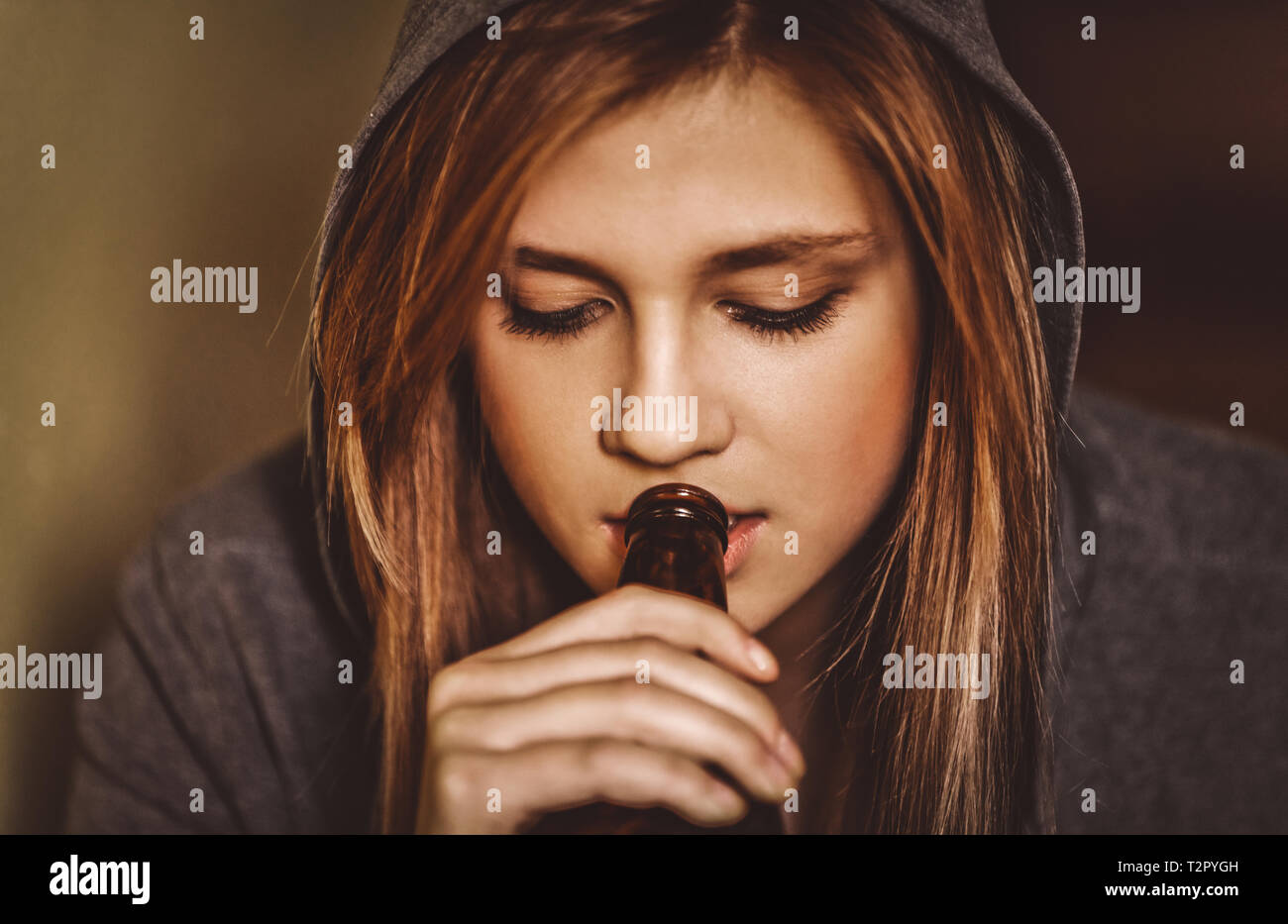 Teenage girl drinking beer from bottle. Drunk teenager with alcohol ...