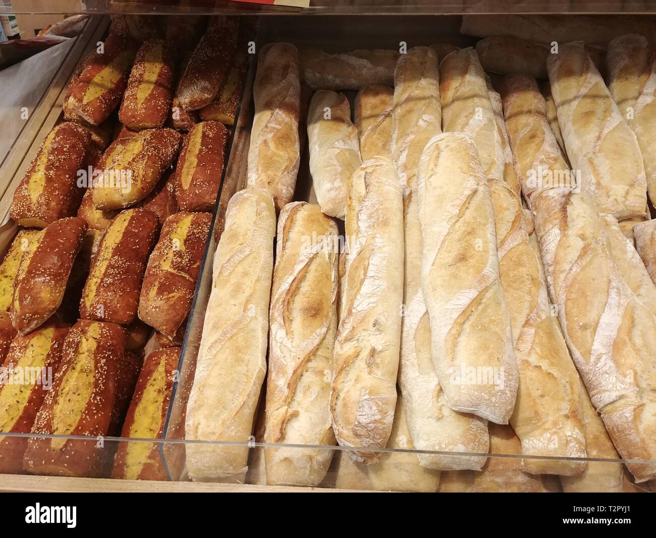 hot freshly baked crisp french baguettes and fancy bread at storefront ...