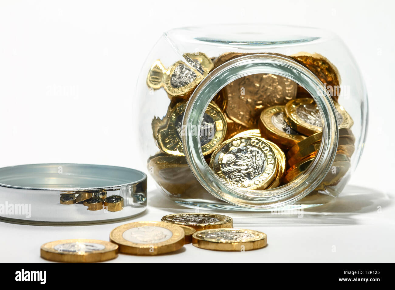 Glass jar full of pound coins isolated on a white background Stock ...