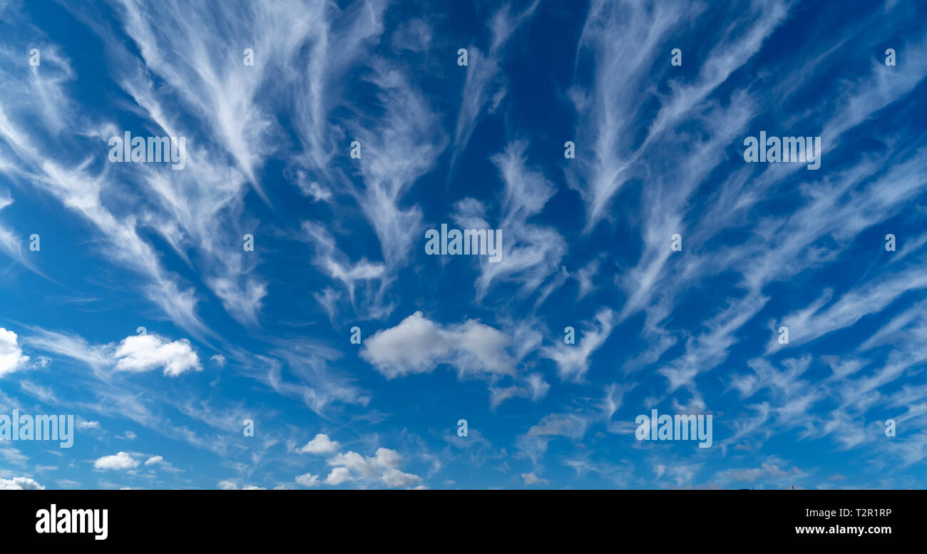 A Photo of a blue sky with white clouds forming different shapes Stock ...